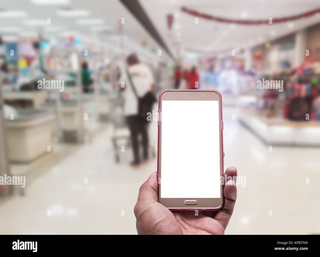 Hand with smartphone on blurred in shopping mall background Stock Photo ...