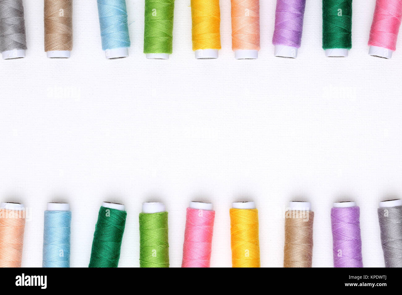 colorful spool of threads on white background Stock Photo - Alamy