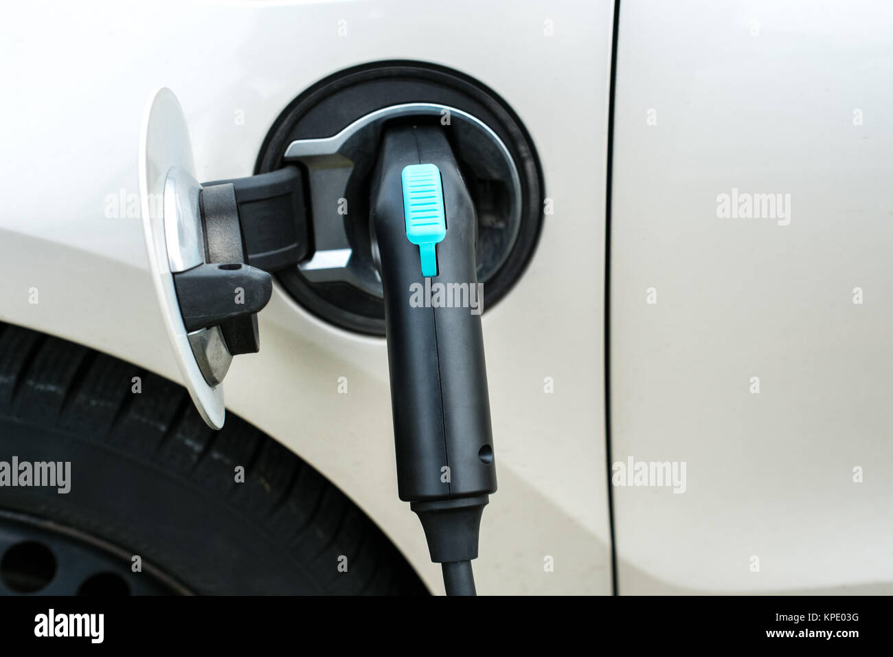 plug charges an electric car on Stock Photo - Alamy