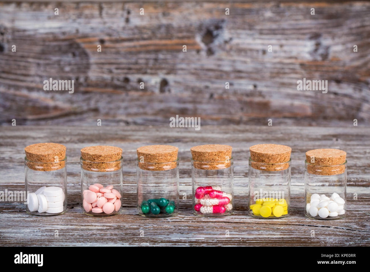 Pills and capsules in glass containers Stock Photo - Alamy