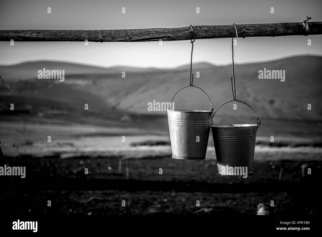Rural Hanging metal buckets Stock Photo - Alamy