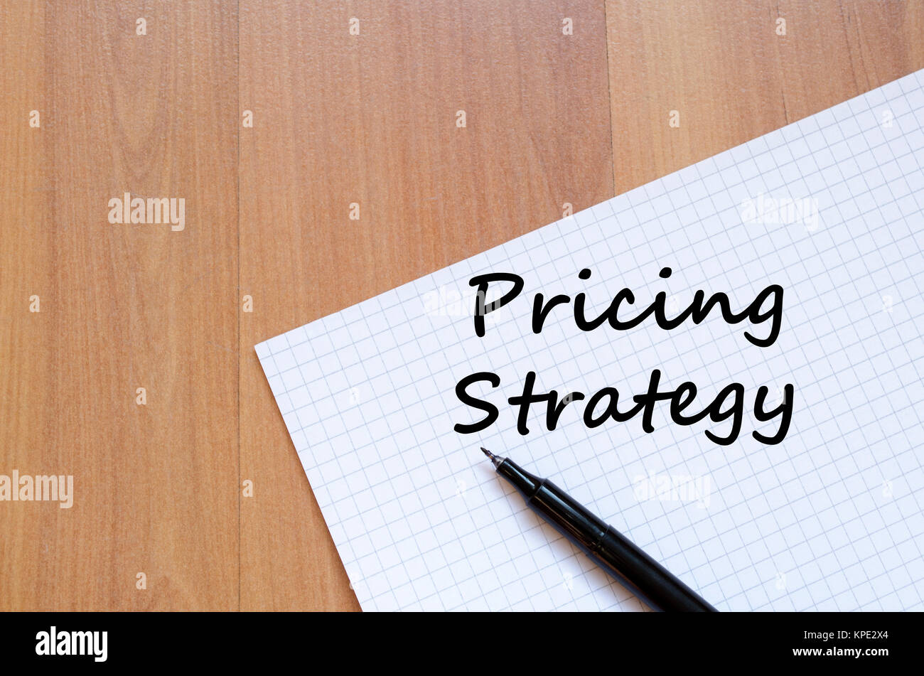 Pricing strategy write on notebook Stock Photo - Alamy
