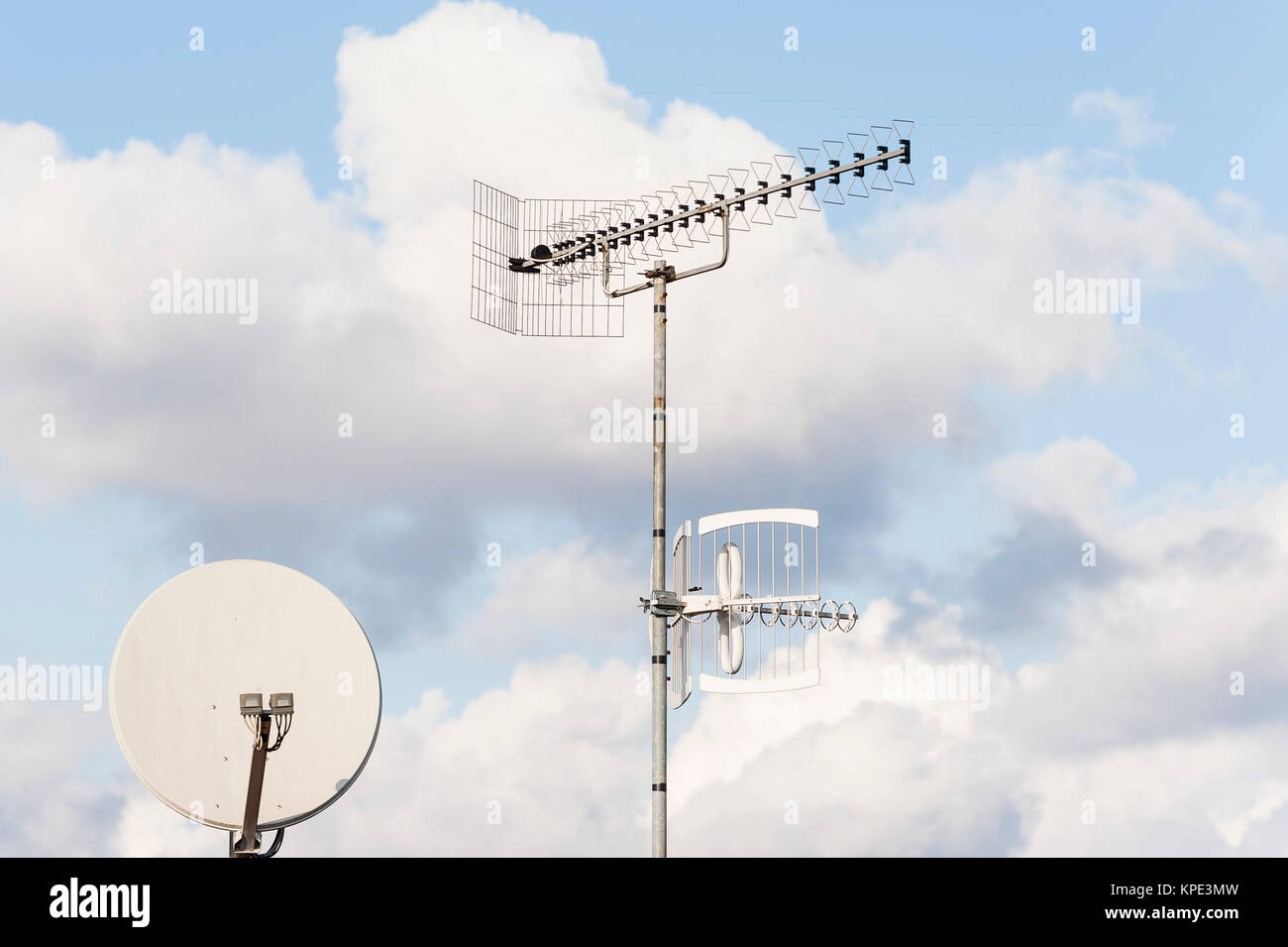 TV aerial and satellite dish against a blue sky Stock Photo - Alamy