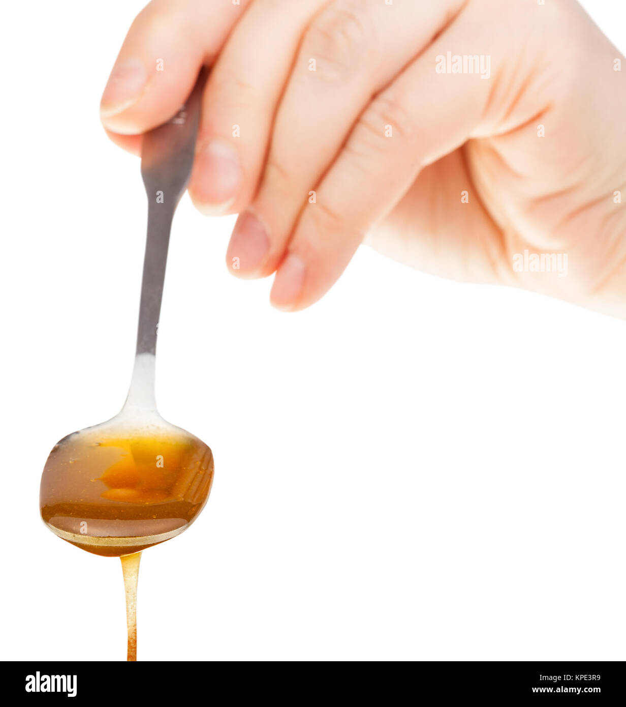 front view of hand holds metal spoon with honey Stock Photo - Alamy