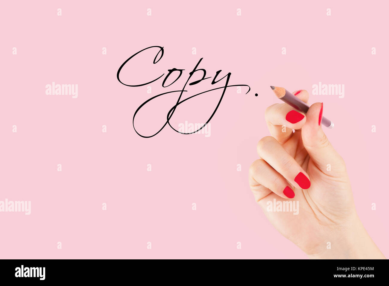 Creative industries. Female hand with pencil writng the word copy in ...