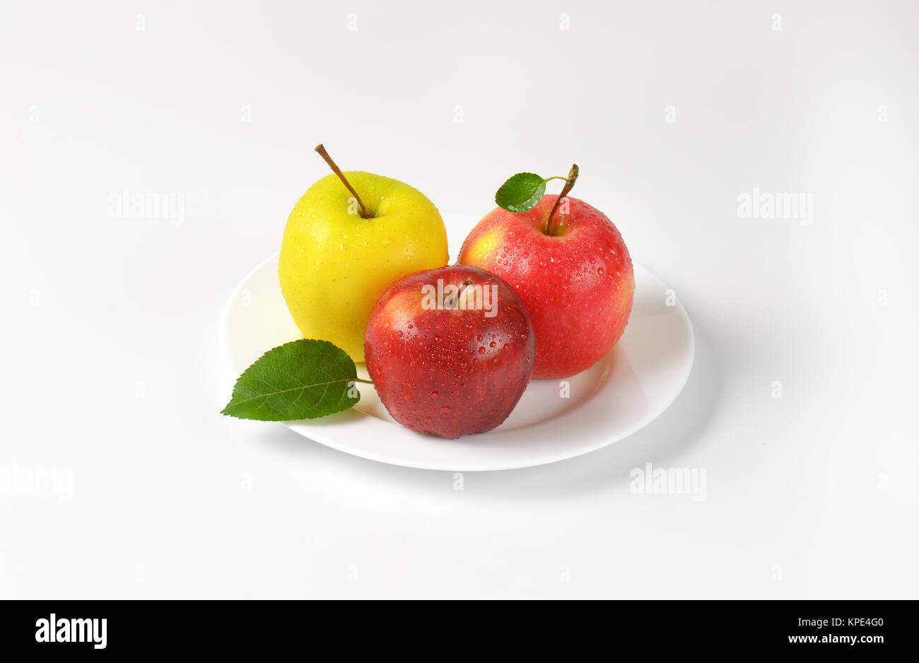 three apples on plate Stock Photo - Alamy