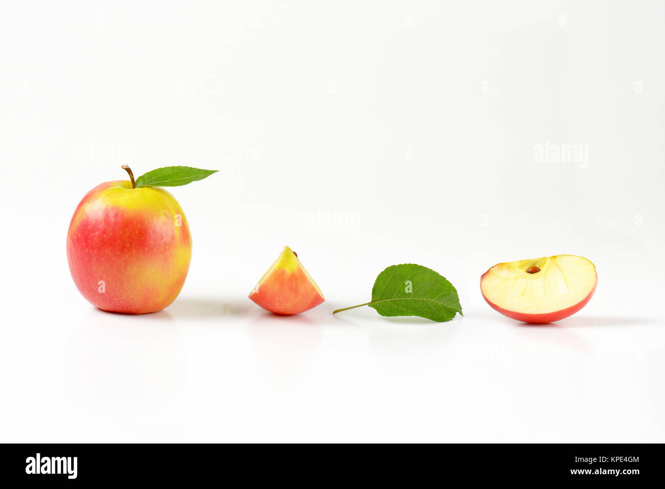 one whole apple and two quarters Stock Photo - Alamy