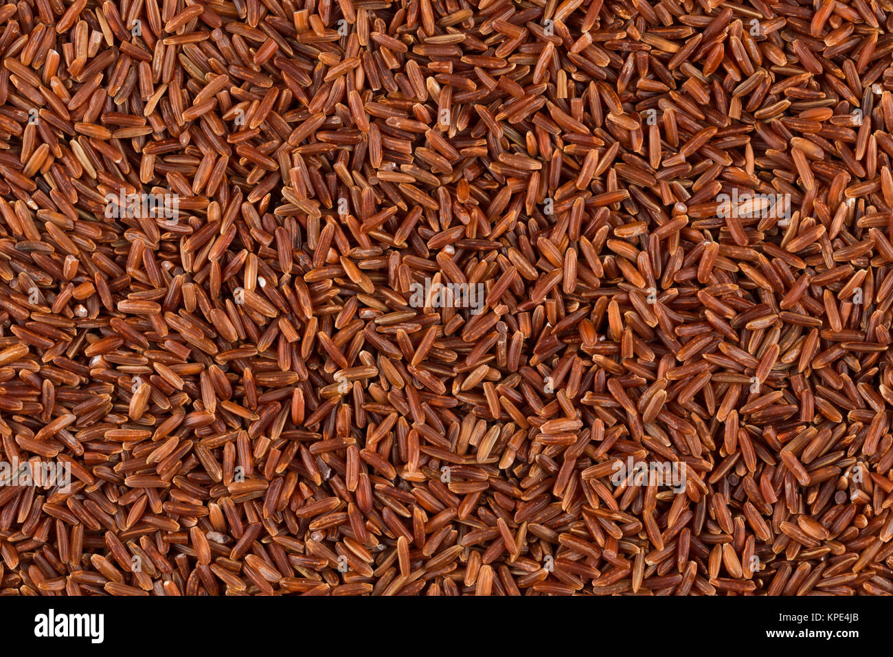 Raw red rice Stock Photo - Alamy