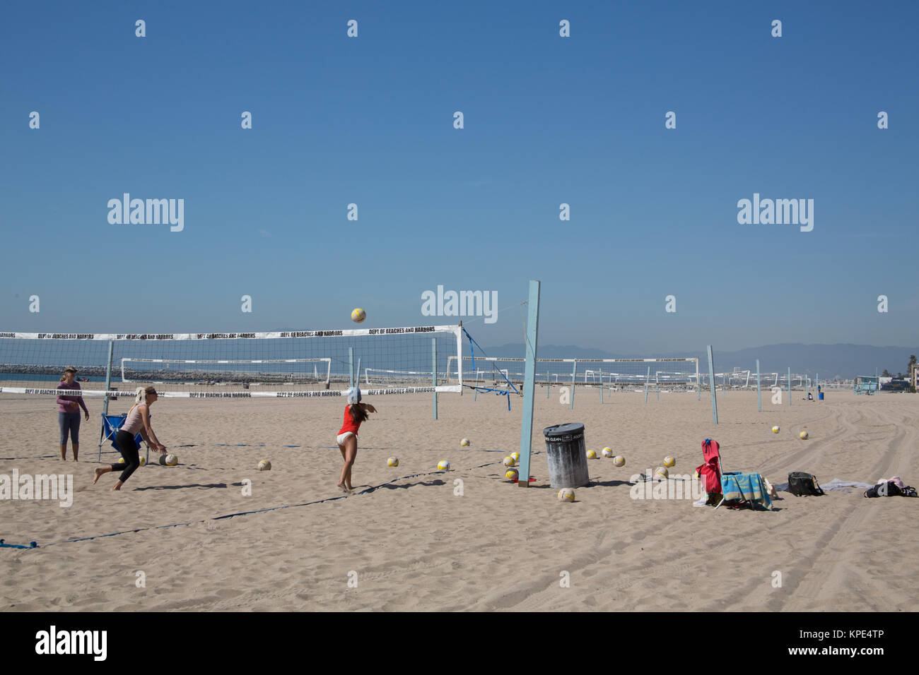 Three women practicing volleyball at Dockweiler State Beach, Los ...