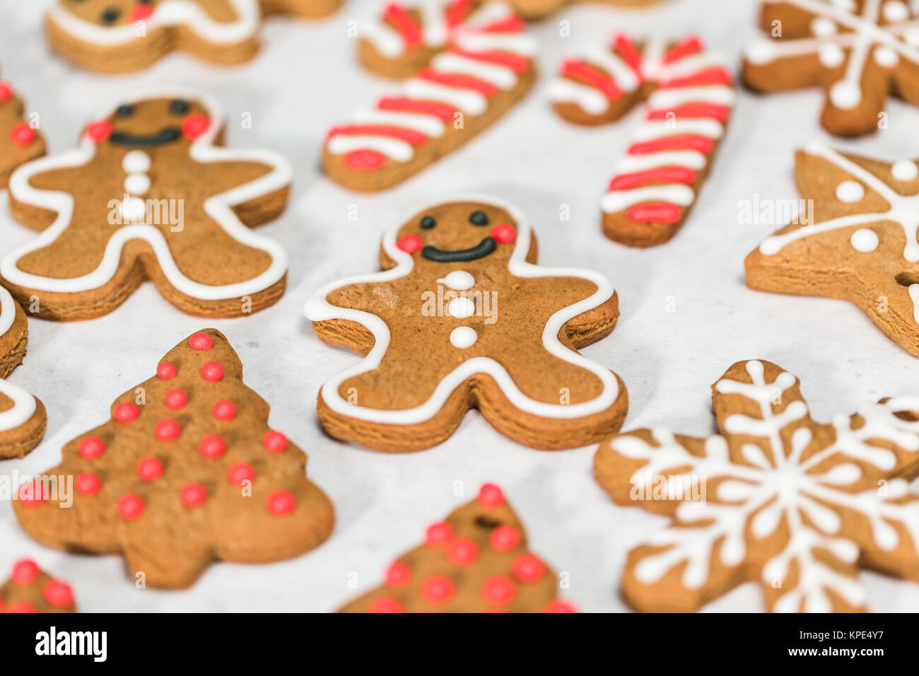 Decorating traditional gingerbread cookies with royal icing for ...