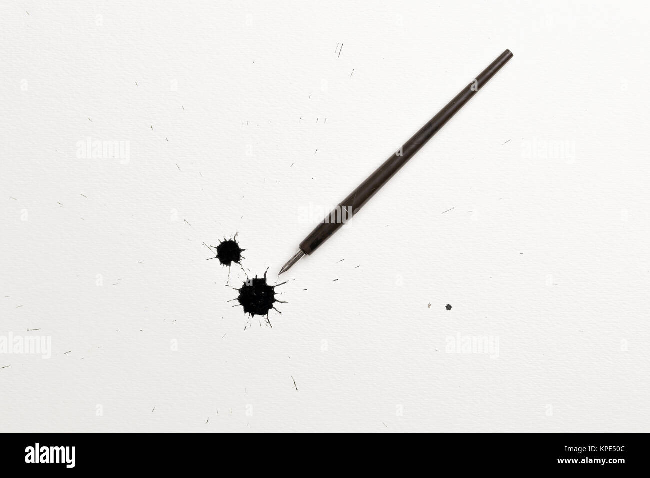 Spattered ink spots with calligraphy pen on white background in check ...