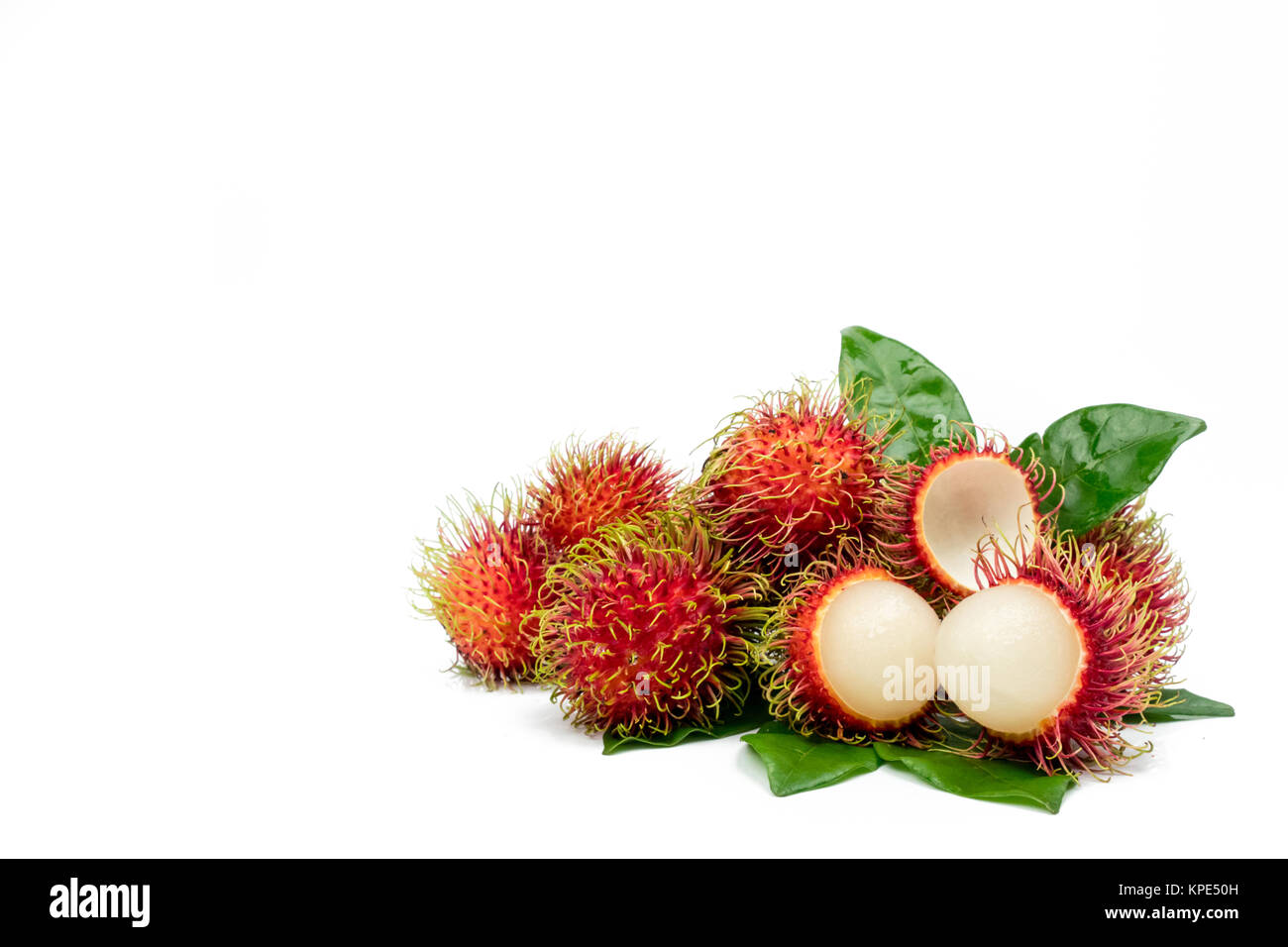 Closeup of fresh red ripe rambutan (Nephelium lappaceum) with leaves ...