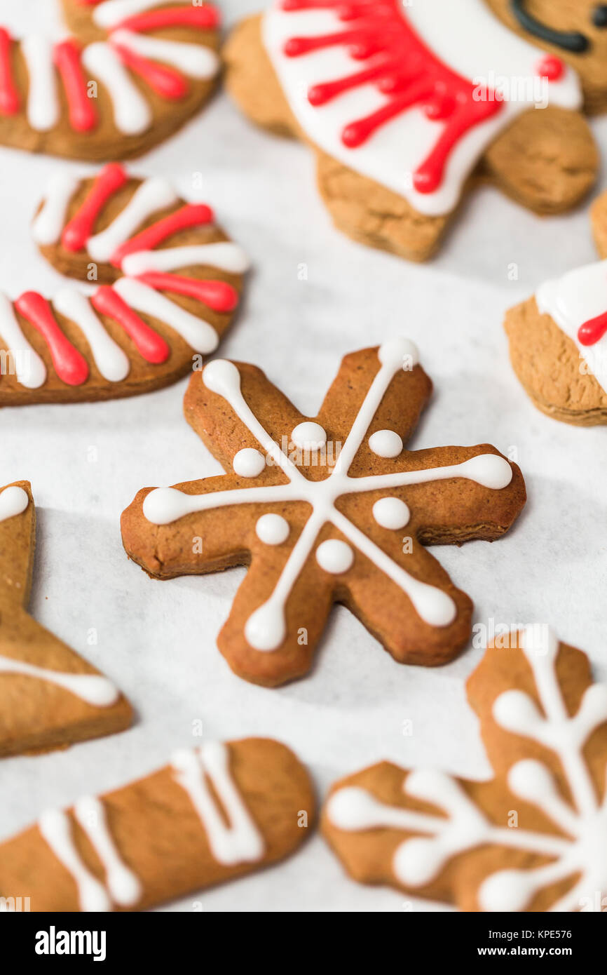 Decorating traditional gingerbread cookies with royal icing for ...