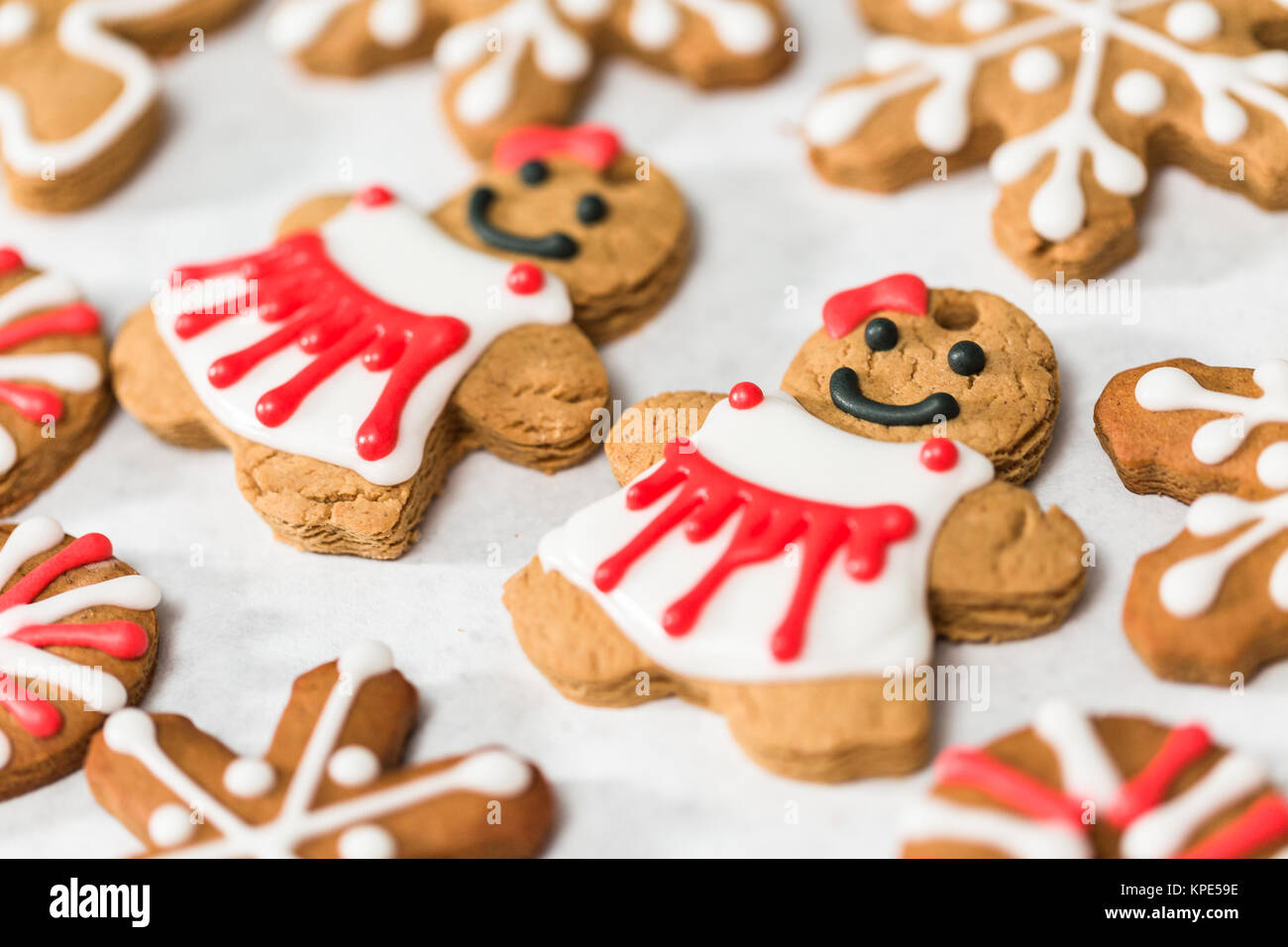 Decorating traditional gingerbread cookies with royal icing for ...
