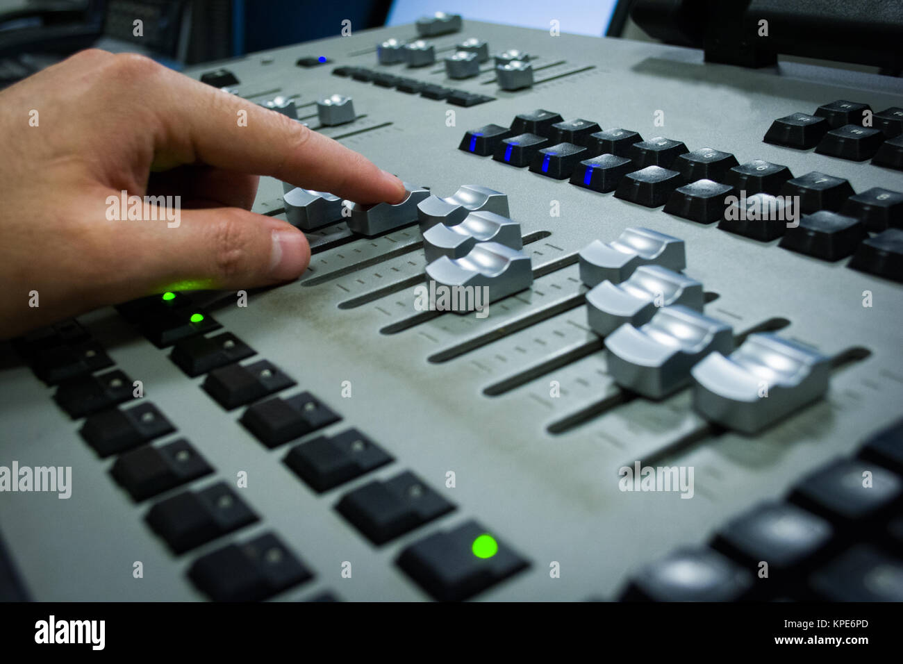hand on a light, mixing desk fader in blur television gallery Stock ...