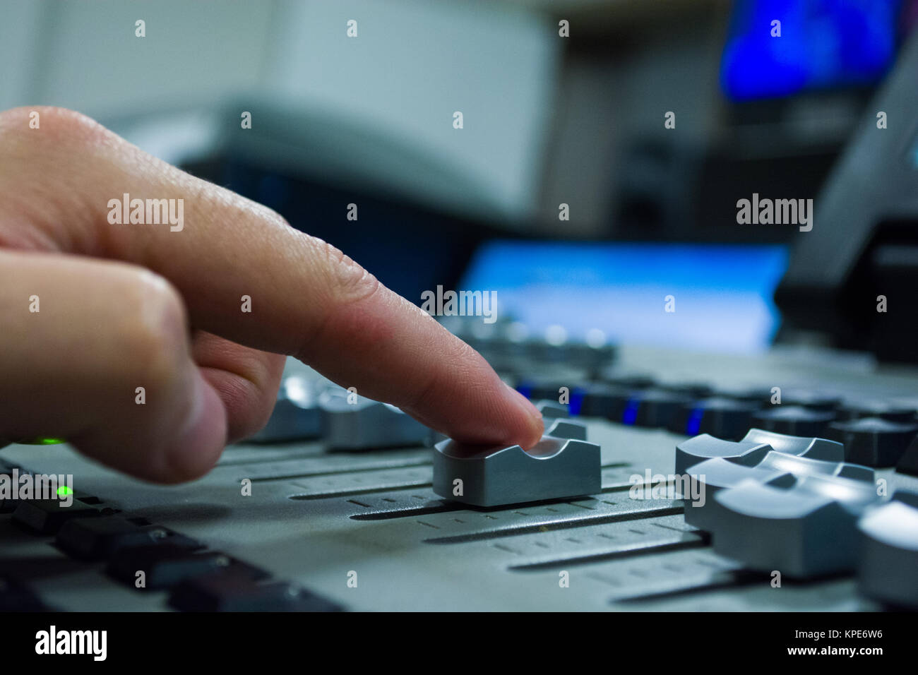 hand on a light, mixing desk fader in blur television gallery Stock ...
