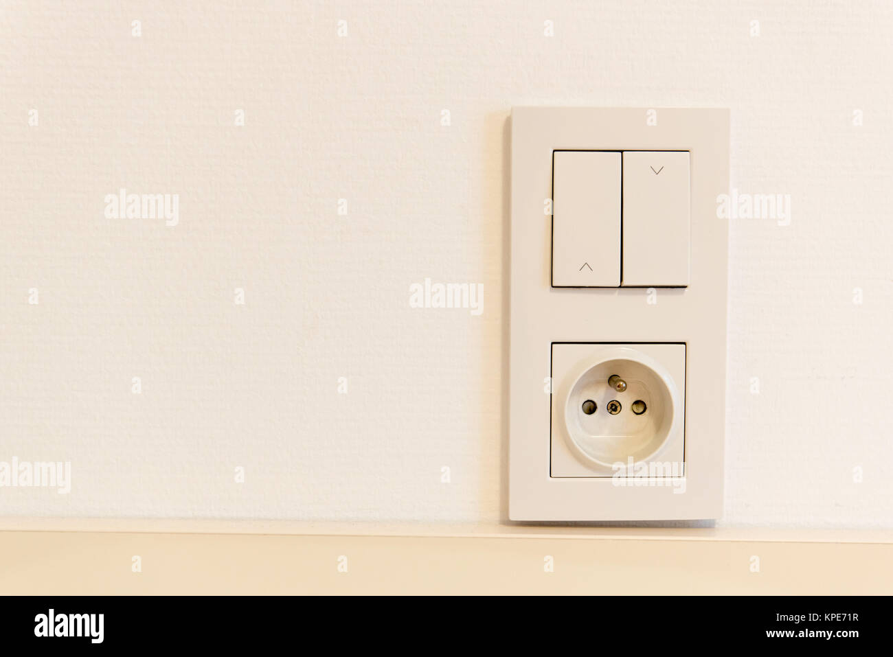 light switch and socket in frame on the wall Stock Photo - Alamy