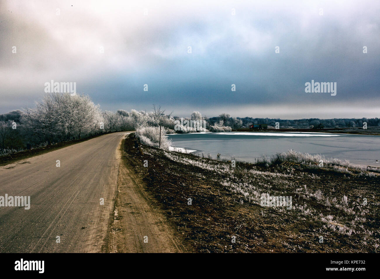 Landscape with a road and a lake Stock Photo - Alamy