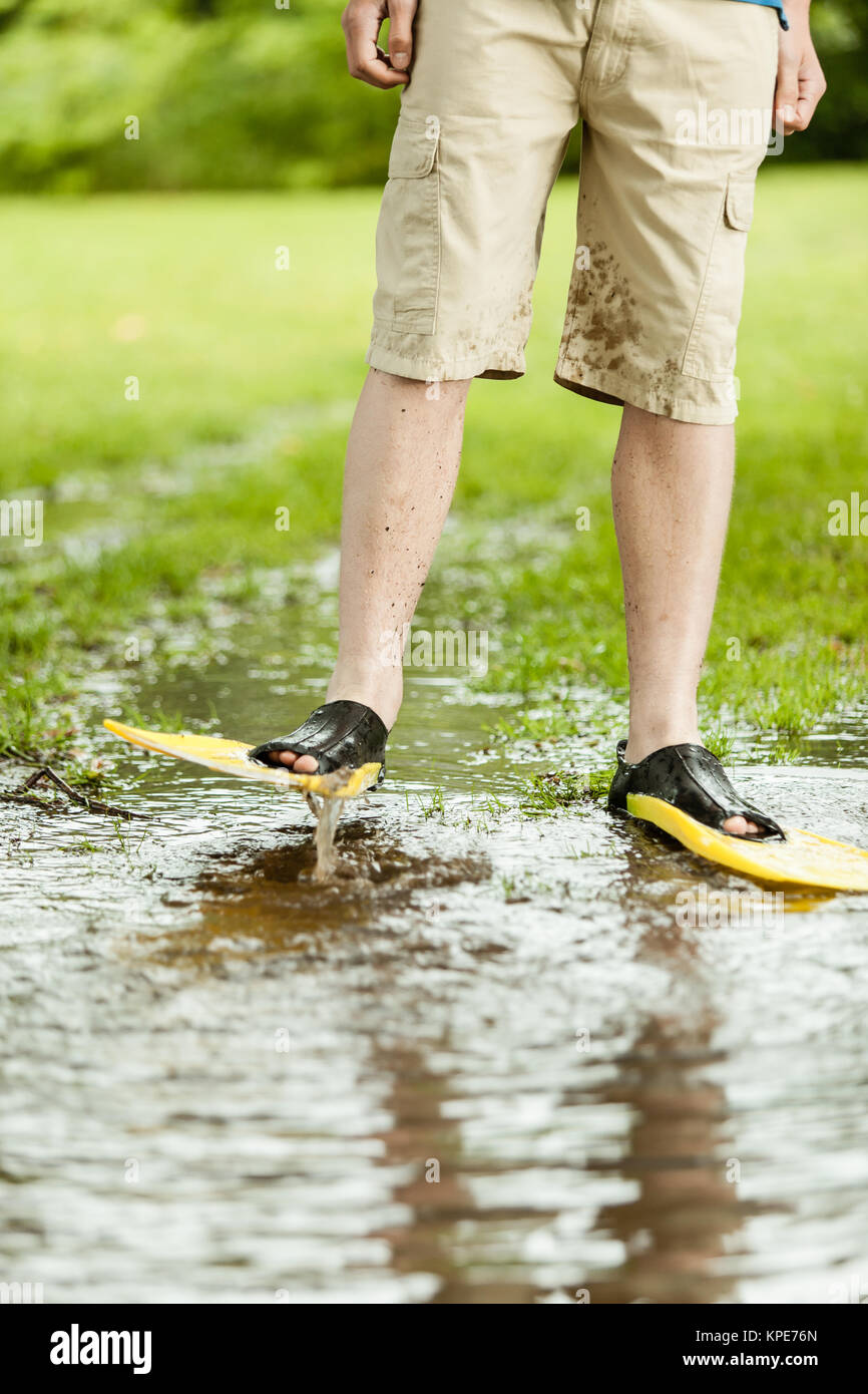 Splashing in puddle with flippers Stock Photo - Alamy