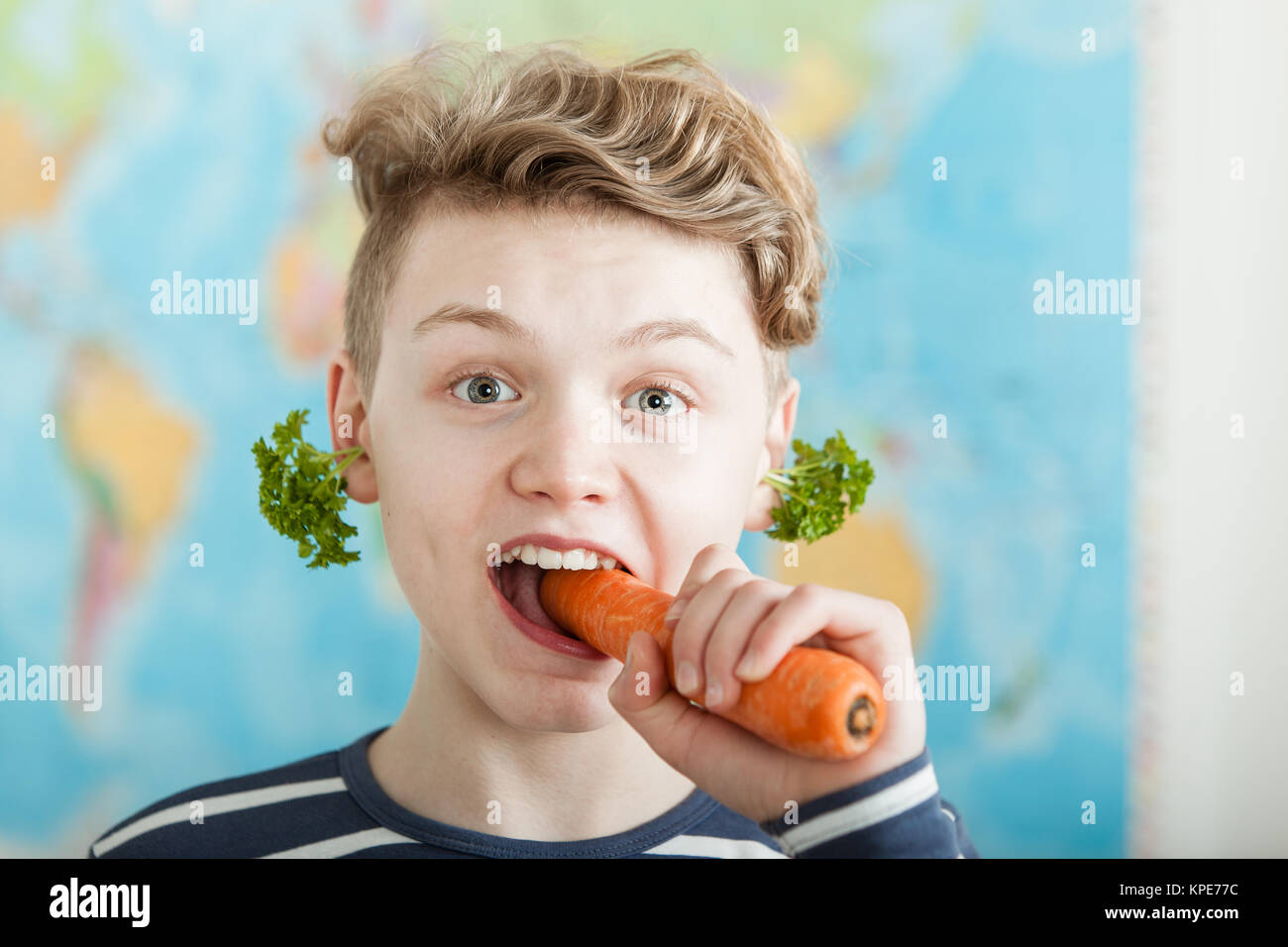 Boy biting carrot hi-res stock photography and images - Alamy
