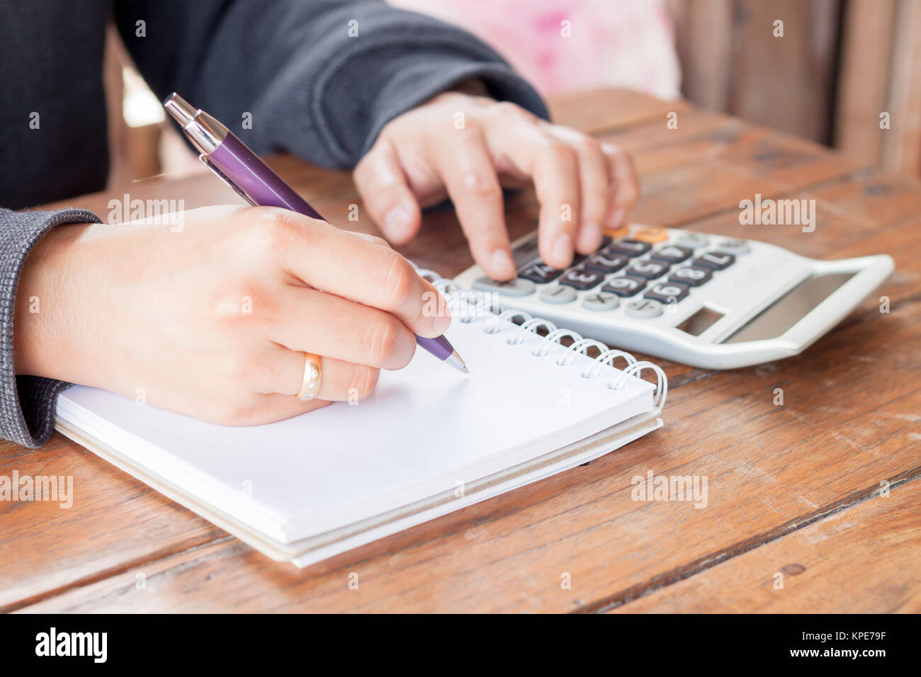 Woman hand with pen writing on notebook Stock Photo - Alamy