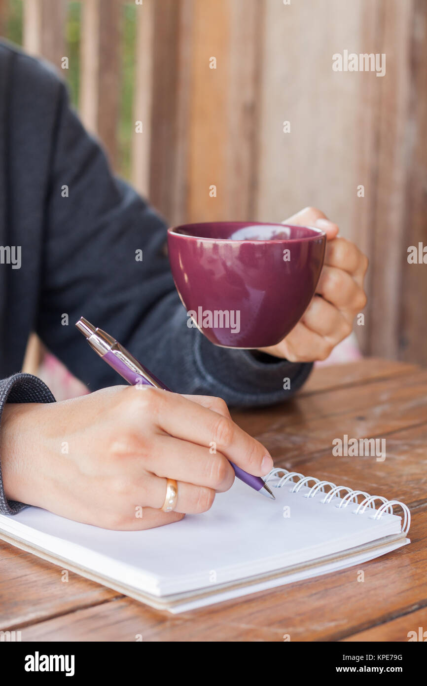 Woman hand with pen writing on notebook Stock Photo - Alamy