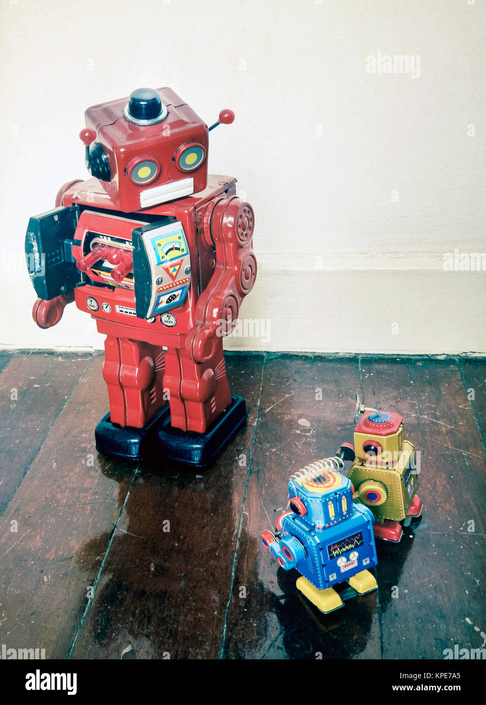 Boss robots looking down on his working robots on wooden floor with ...