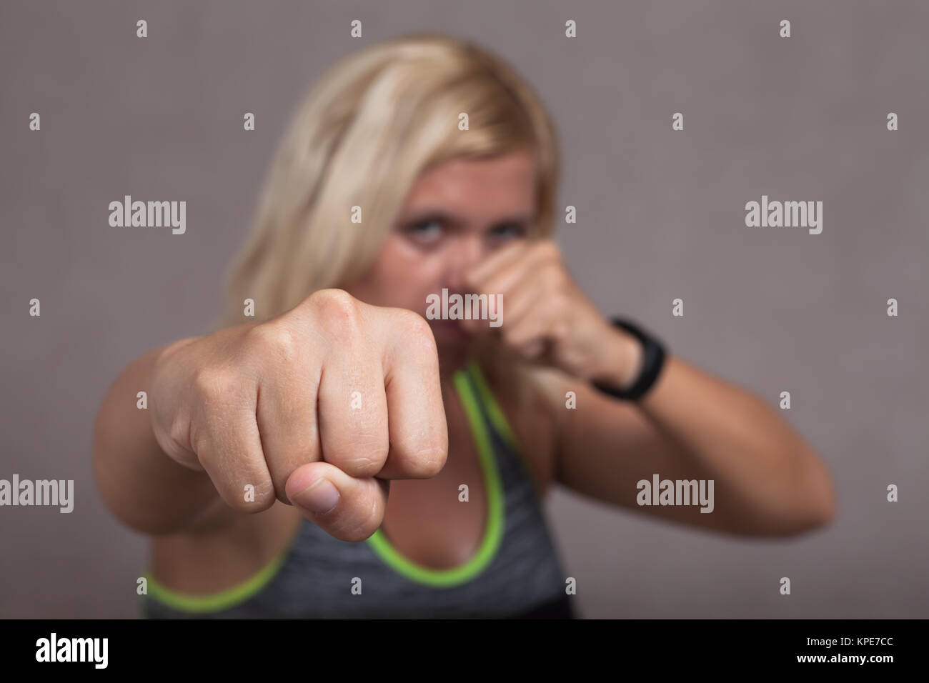 Dangerous female fighter showing fist Stock Photo - Alamy