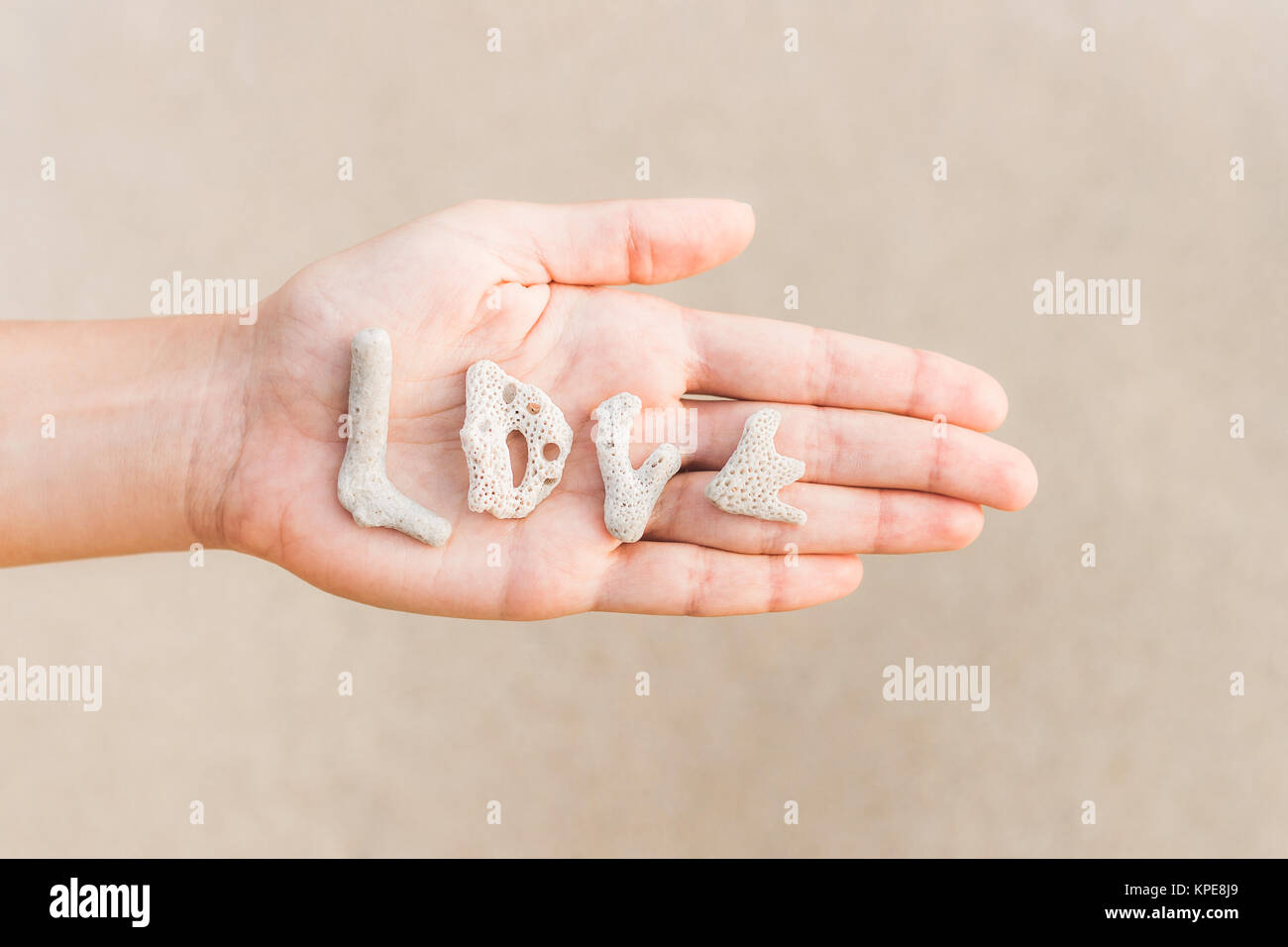 Word love made of shells on woman hand Stock Photo - Alamy
