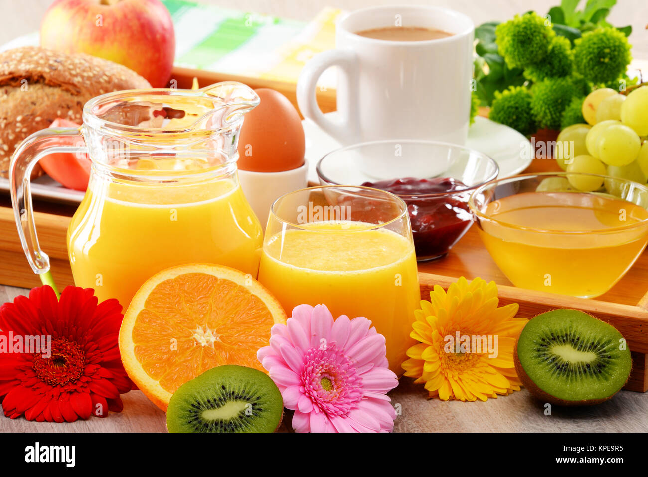 Breakfast on tray served with coffee, juice, egg, and rolls Stock Photo ...