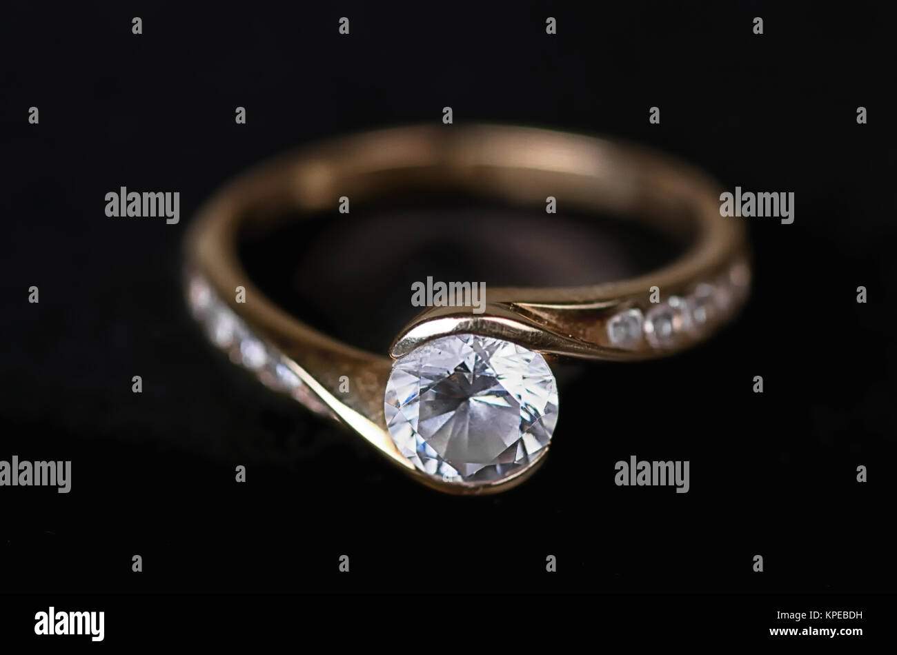gold ring with diamonds on a black background Stock Photo - Alamy