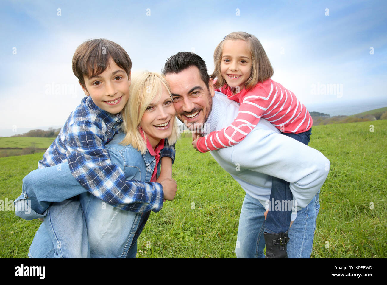Portrait of happy family in countryside Stock Photo - Alamy