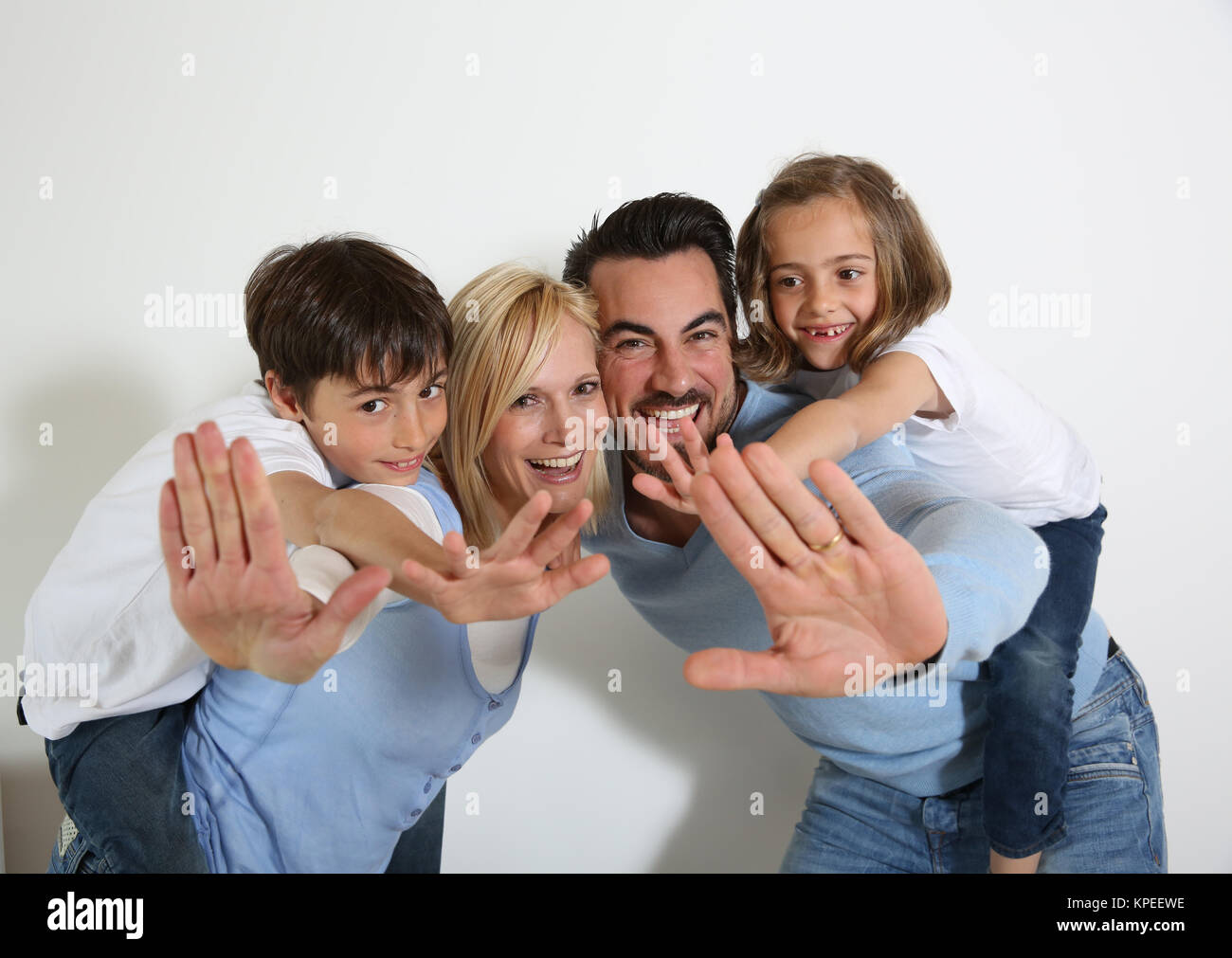 Family of four standing on white background Stock Photo - Alamy