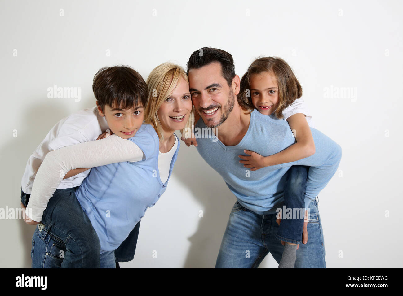 Family of four standing on white background Stock Photo - Alamy
