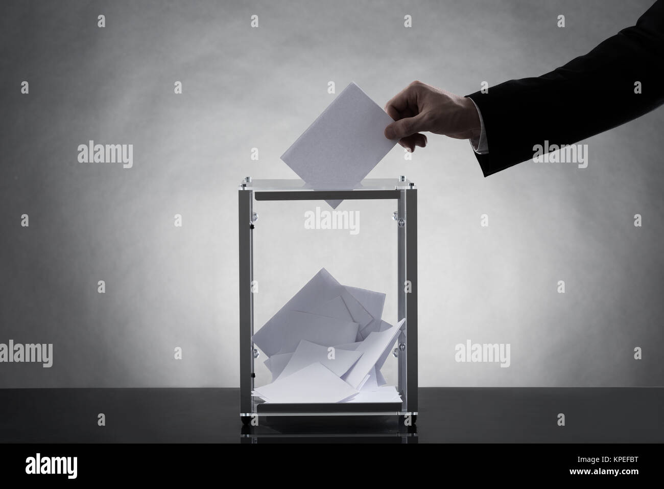 Hand Putting Ballot In Glass Box Stock Photo - Alamy
