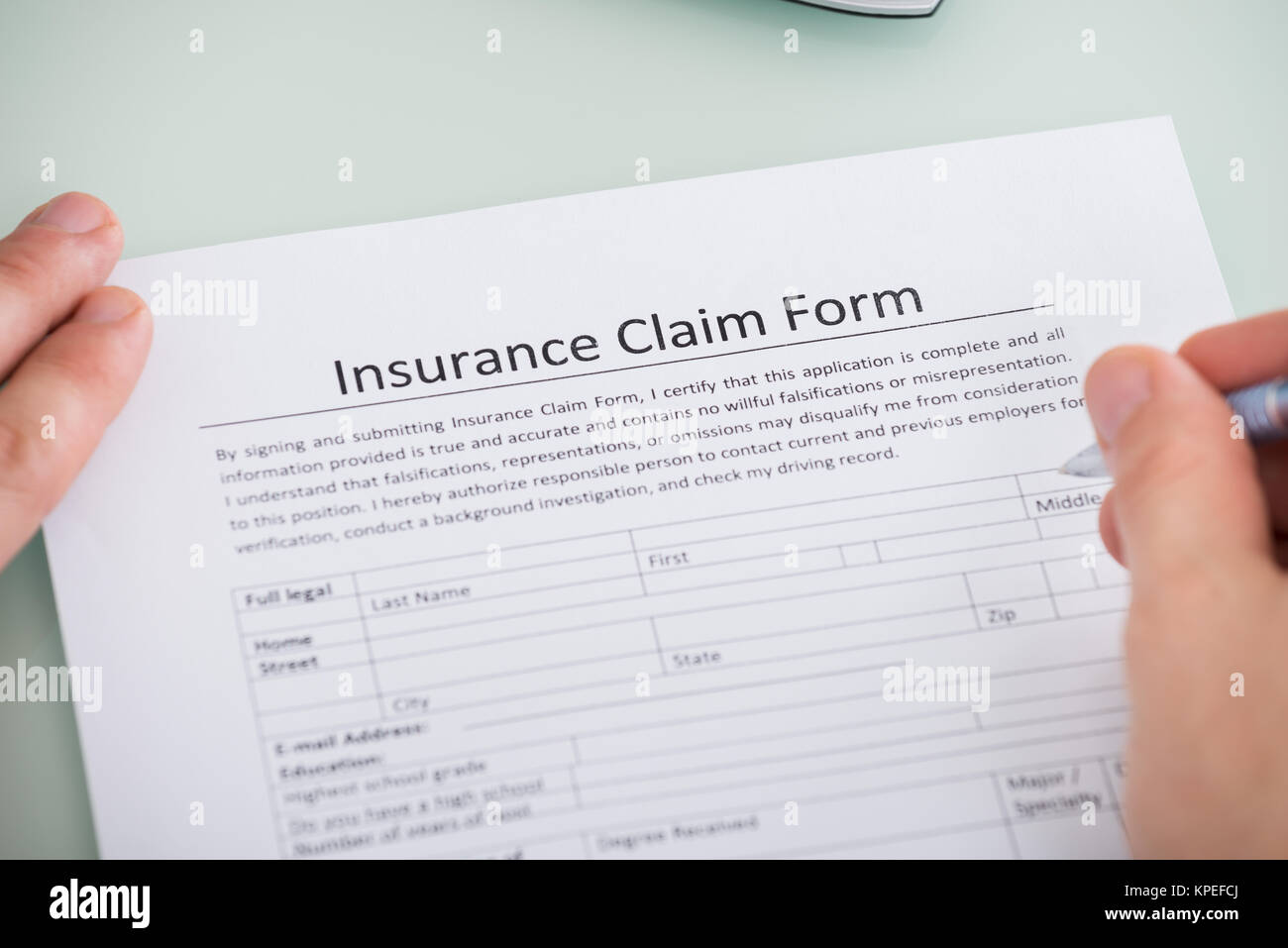 Person Hand Over Insurance Claim Form Stock Photo - Alamy