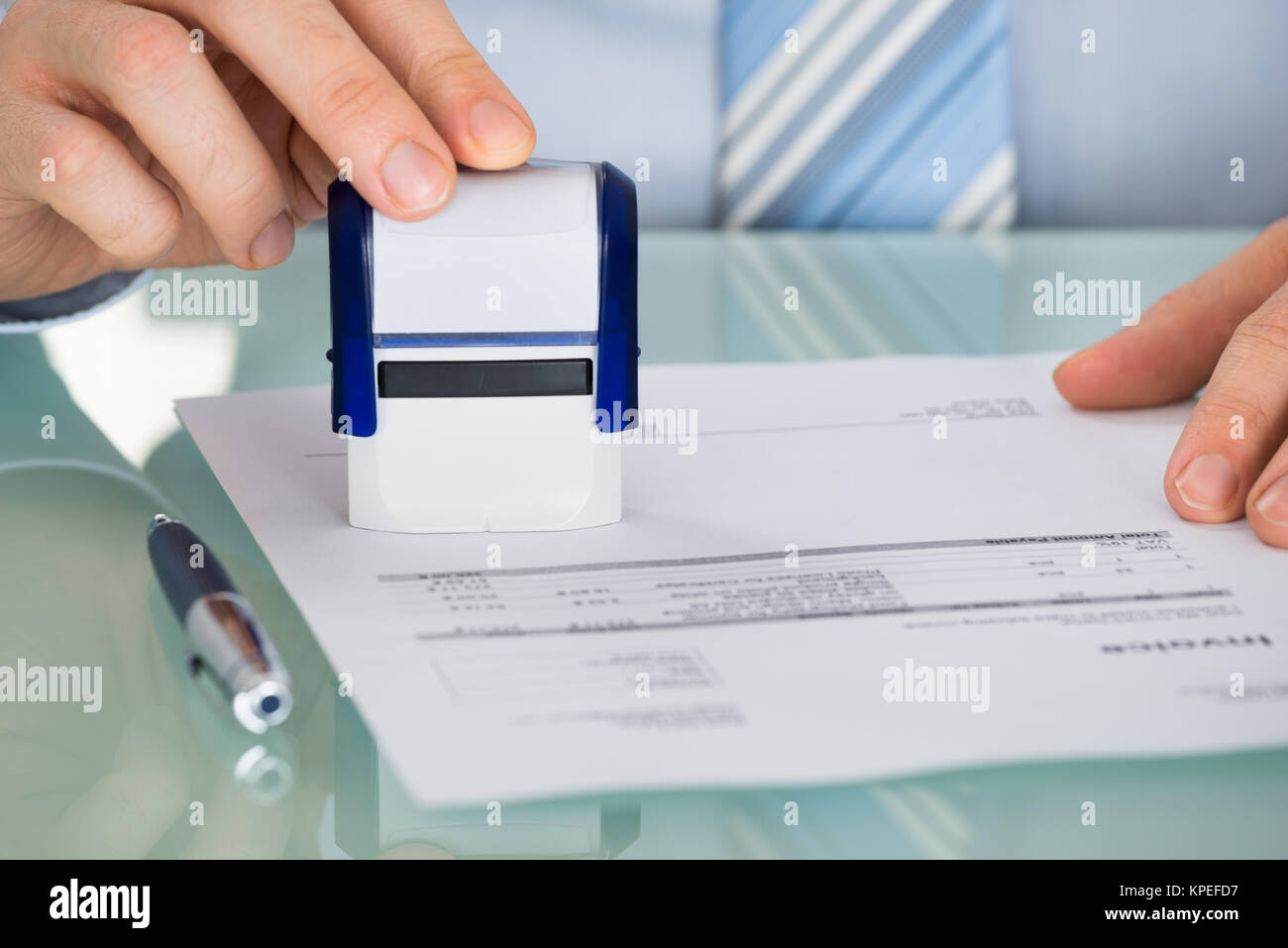 Person's Hand Pressing Stamper On Document Stock Photo - Alamy