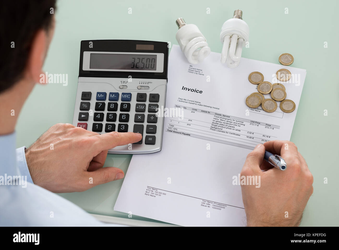 Businessman Checking Invoice With Calculator Stock Photo - Alamy