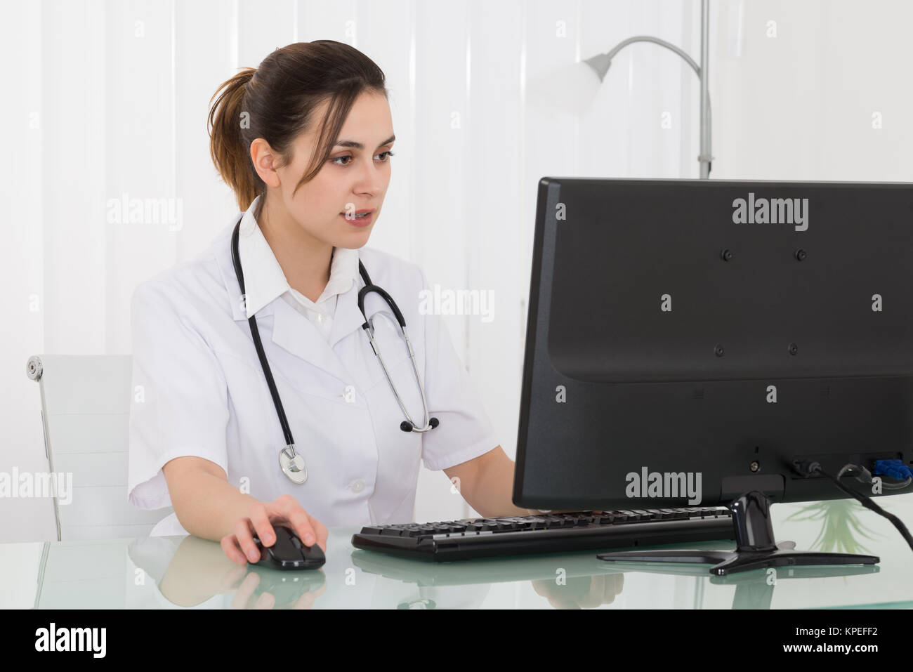 Young Female Doctor Working On Computer Stock Photo - Alamy