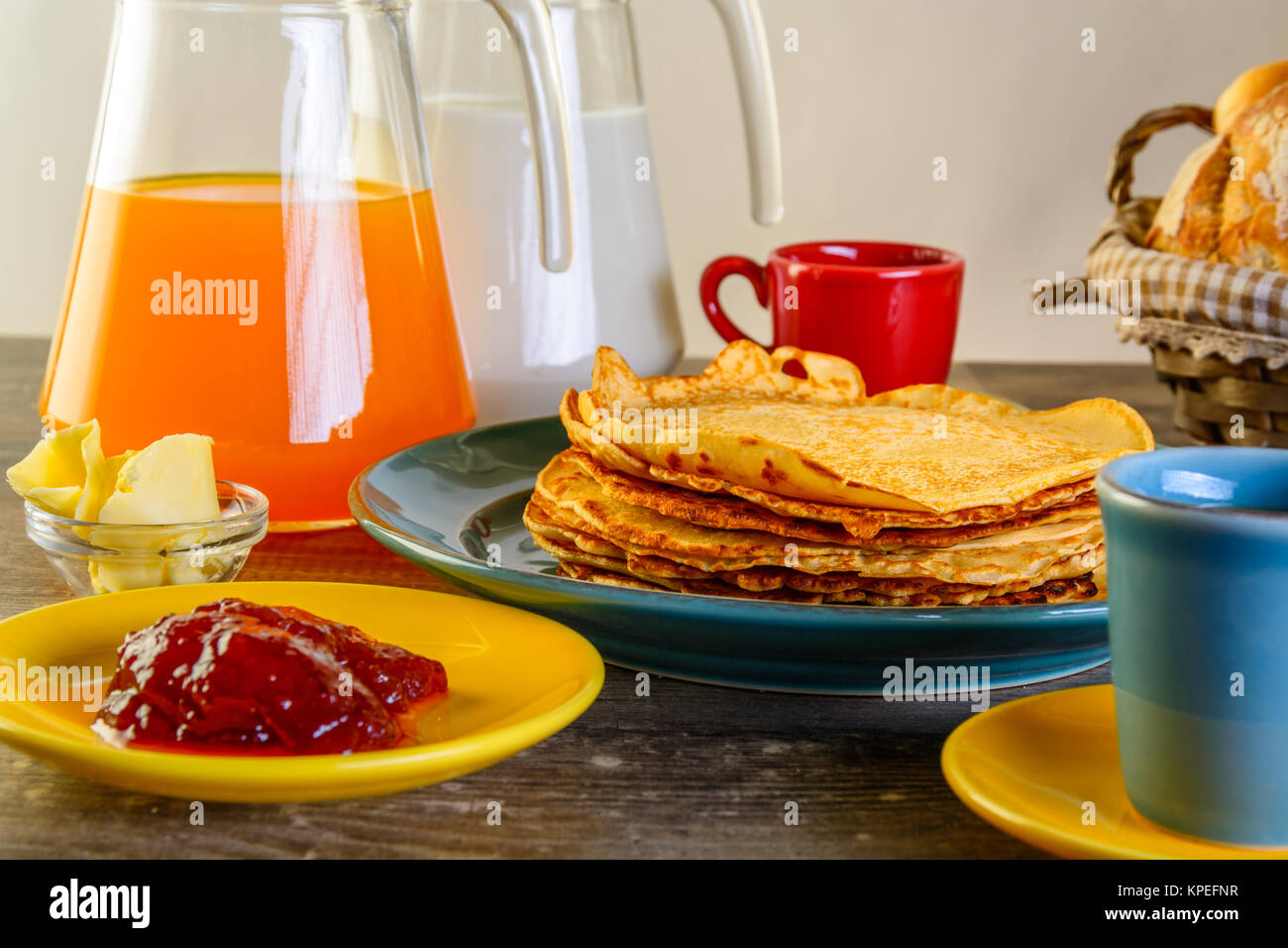 table of breakfast full set with eggs, pancakes, bread, jam ,juice and ...