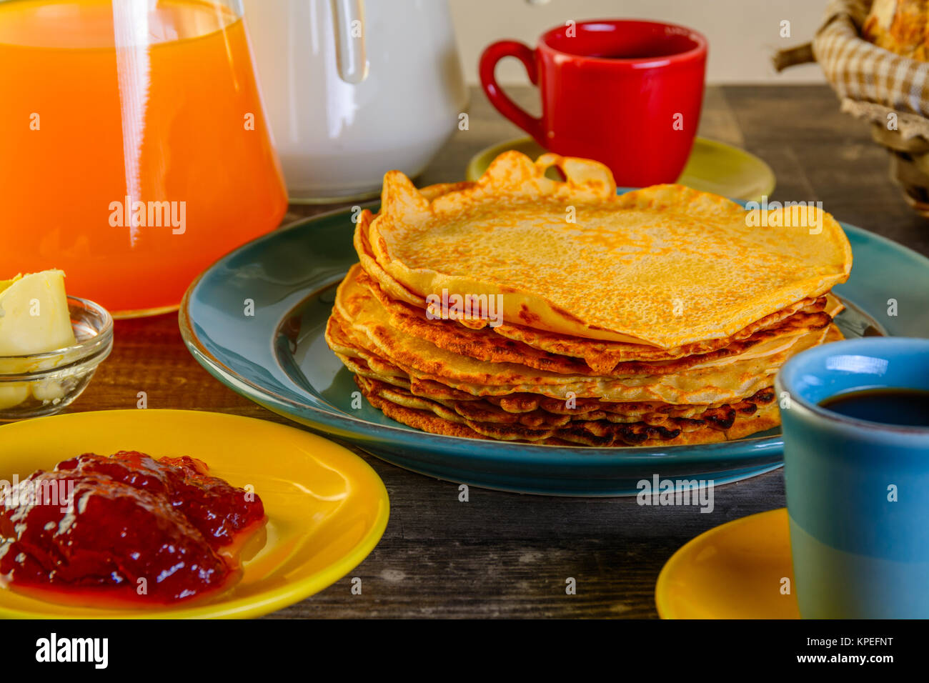 table of breakfast full set with eggs, pancakes, bread, jam ,juice and ...