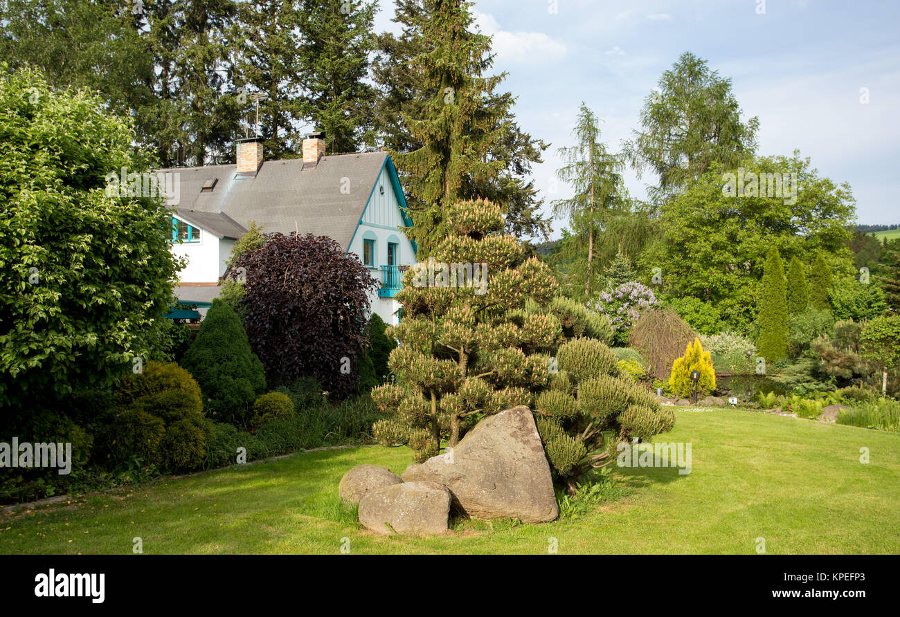 Beautiful house in spring garden Stock Photo - Alamy