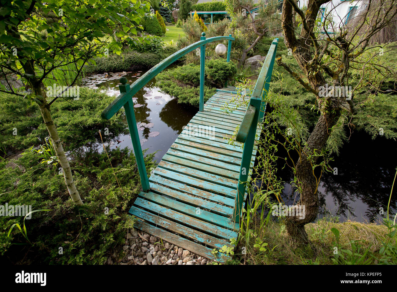 small green footbridge over a pond Stock Photo - Alamy