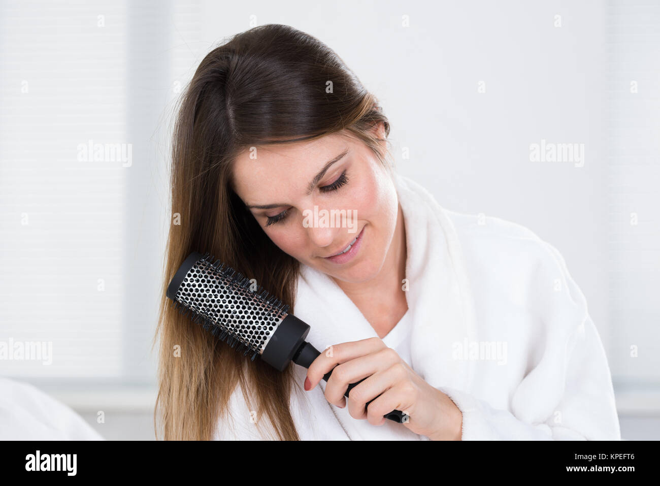 Woman Combing Her Hair Stock Photo - Alamy