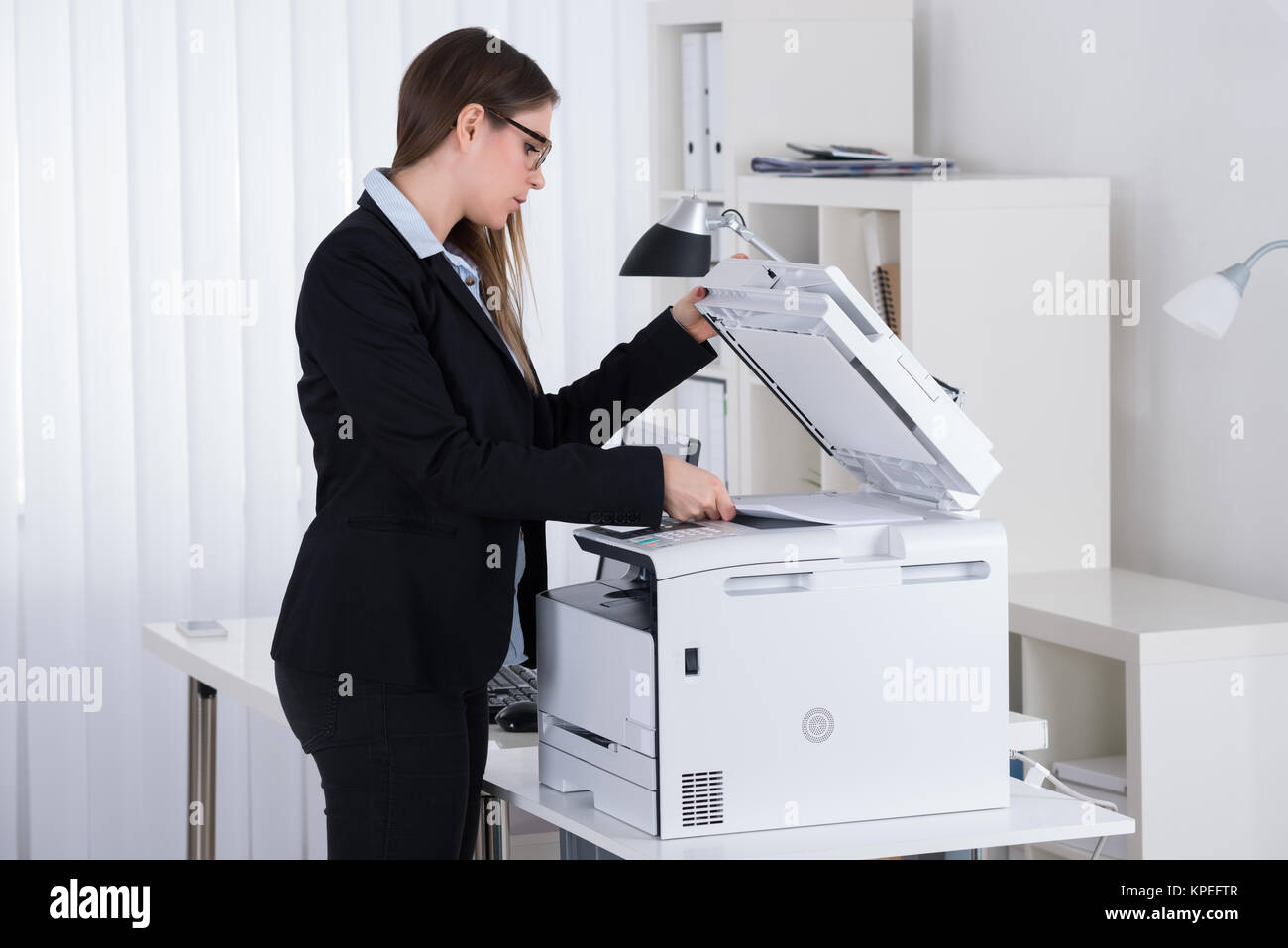 Businesswoman Using Printer Machine Stock Photo - Alamy