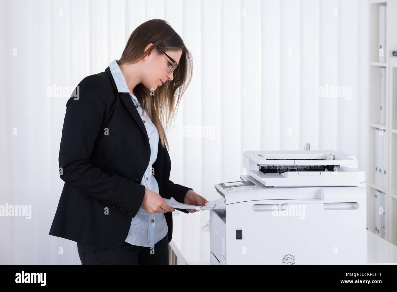Businesswoman Using Copy Machine Stock Photo - Alamy
