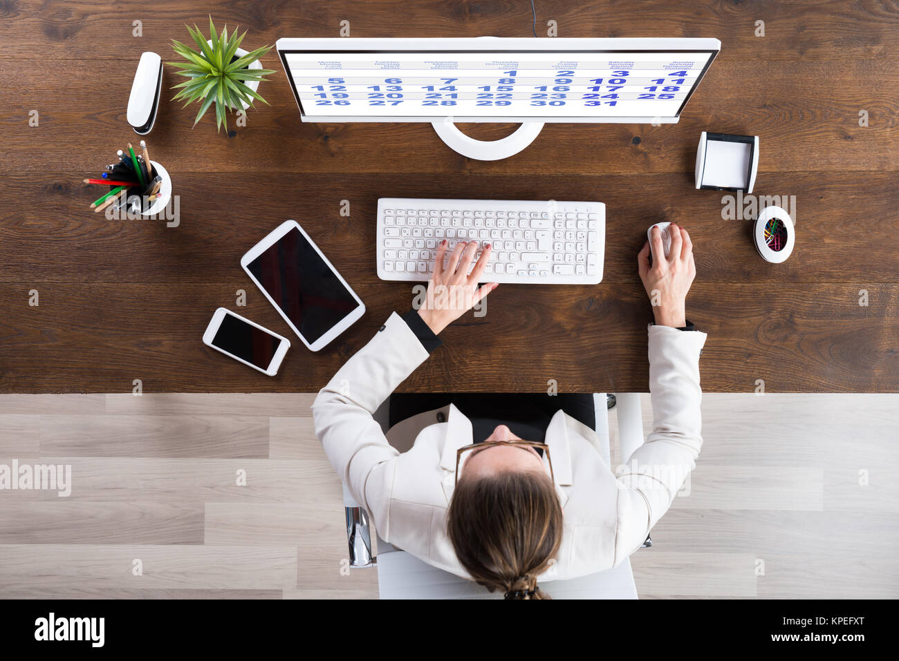 Businesswoman Looking At Calendar On Computer Stock Photo - Alamy