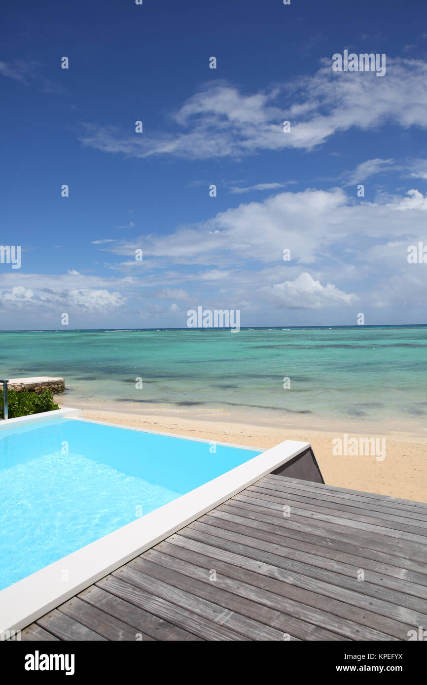 Beautiful view of infinity pool with wooden deck Stock Photo - Alamy