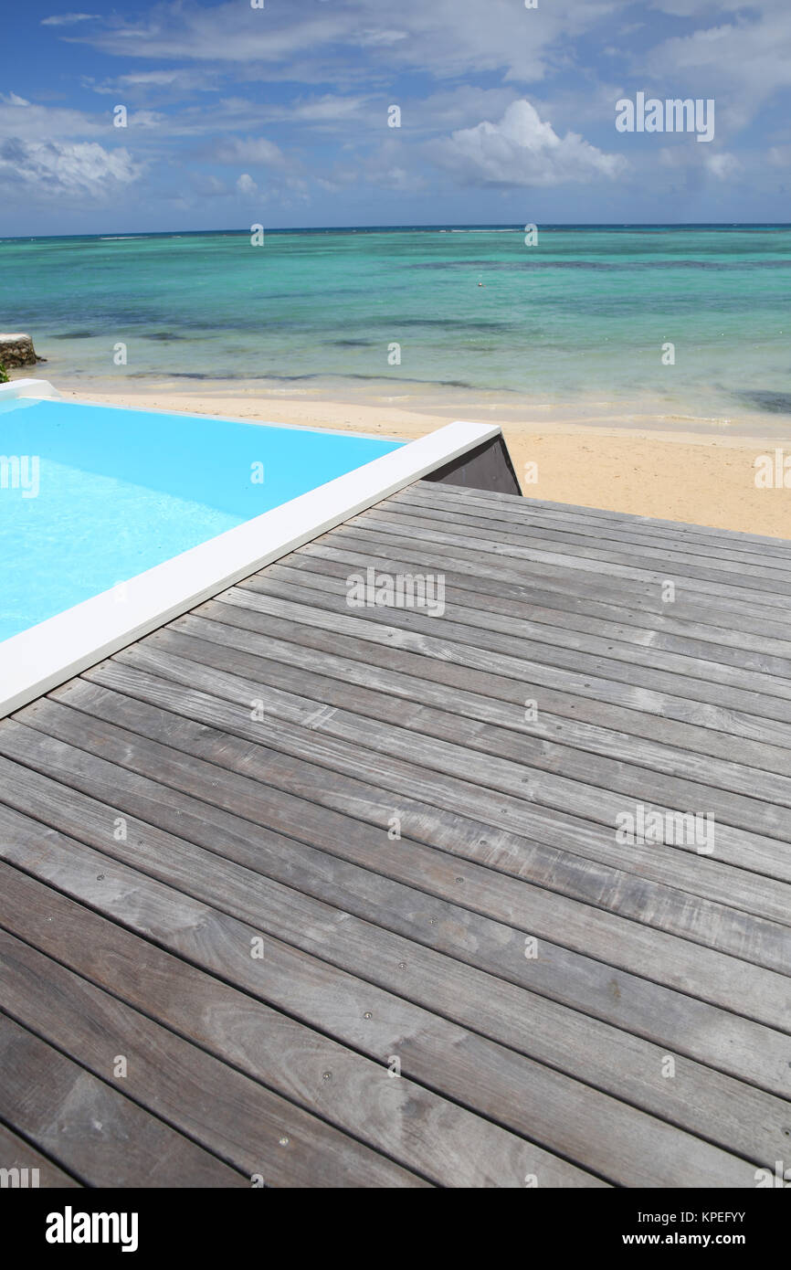 Beautiful view of infinity pool with wooden deck Stock Photo - Alamy