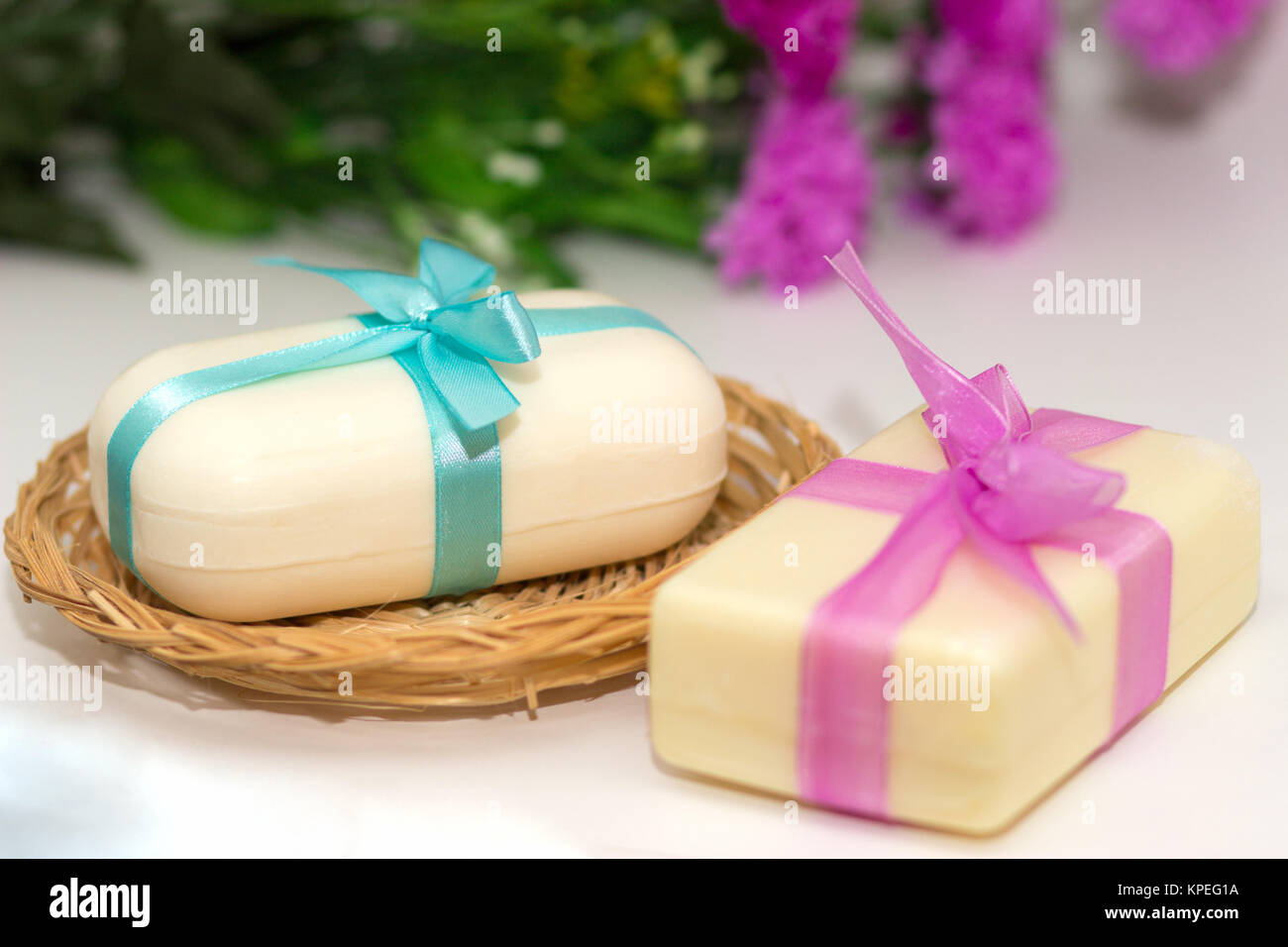 Two pieces of soap with a basket with a bow and flowers Stock Photo - Alamy